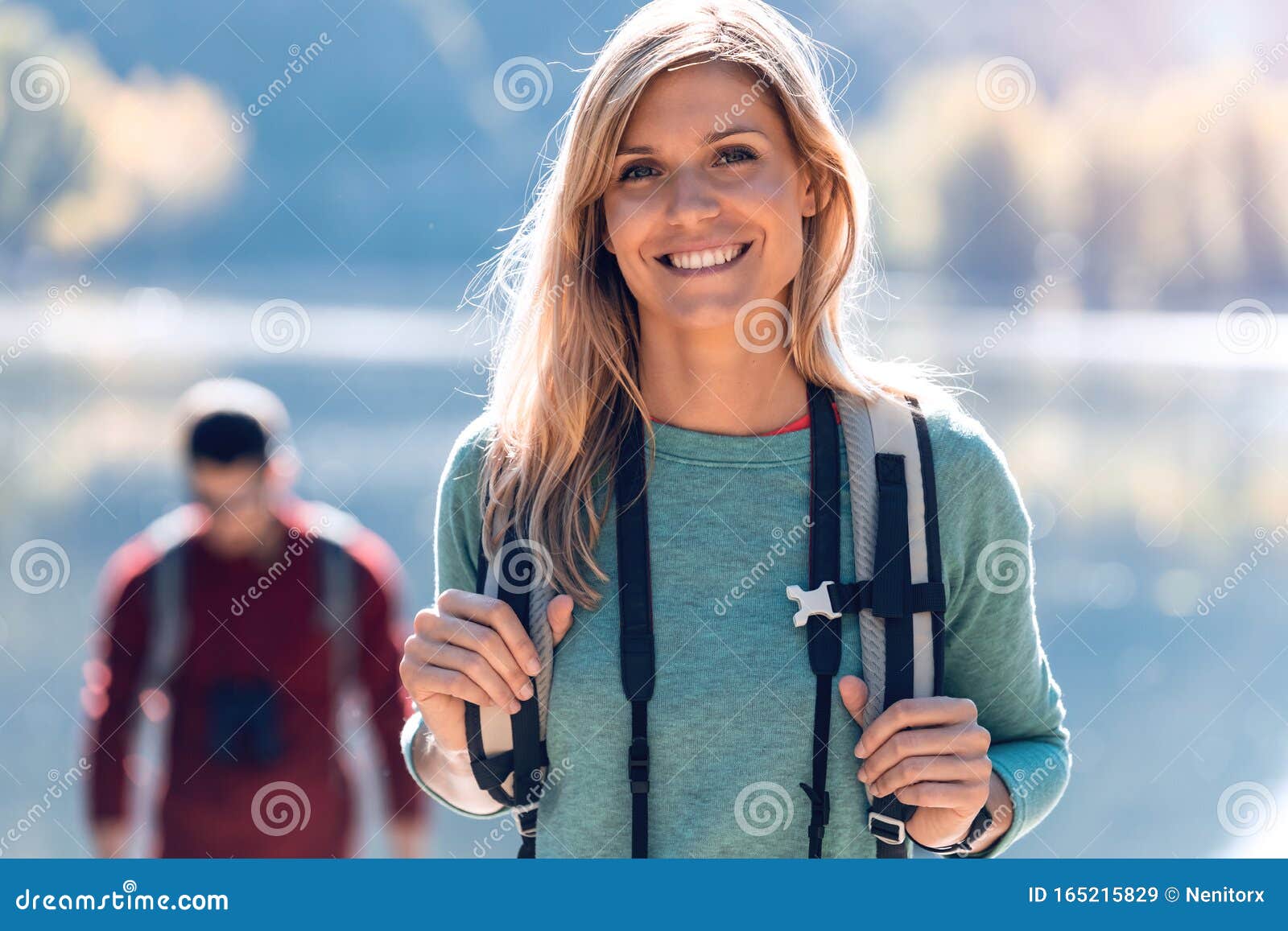 Pretty Young Female Hiker Smiling while Looking at Camera in Front of ...