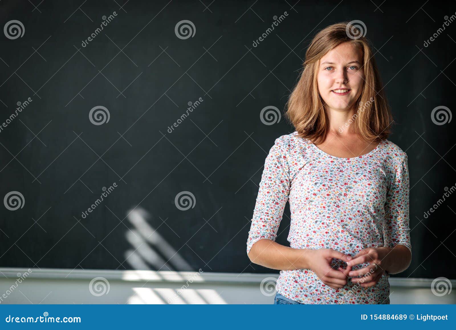Pretty, Young Female Student/young Teacher in Front of a Blackboard ... Pretty, Young Female Student/young Teacher in Front of a Blackboard ...