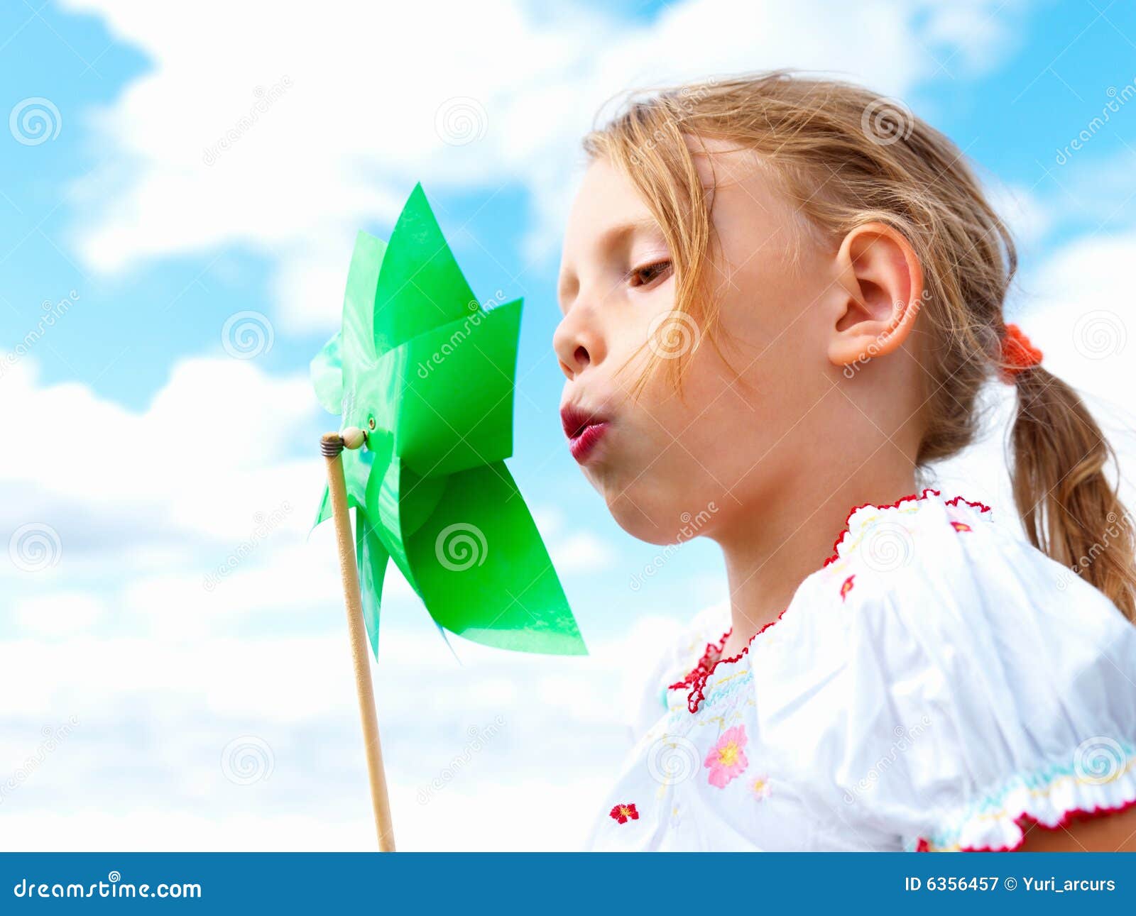 Pretty Young Girl Blowing Pinwheel Stock Image - Image of environment ...
