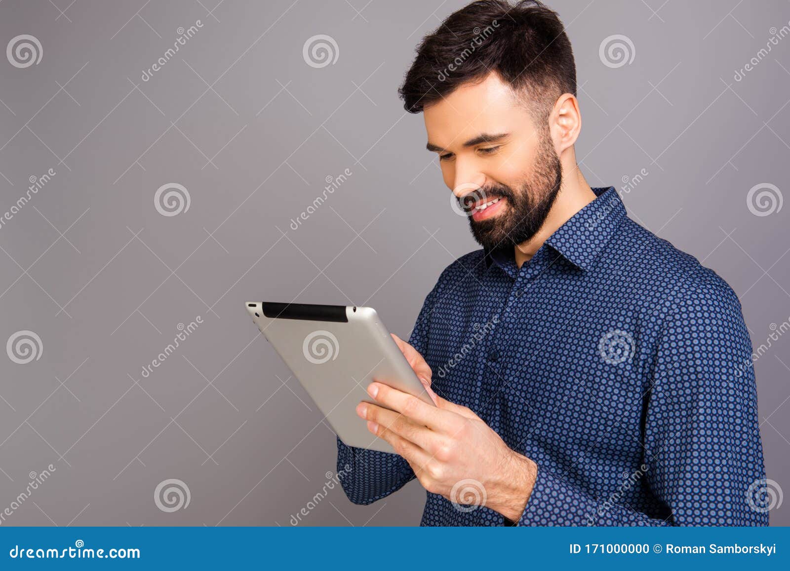 Pretty Young Man Holding Tablet and Reading News Stock Photo - Image of ...
