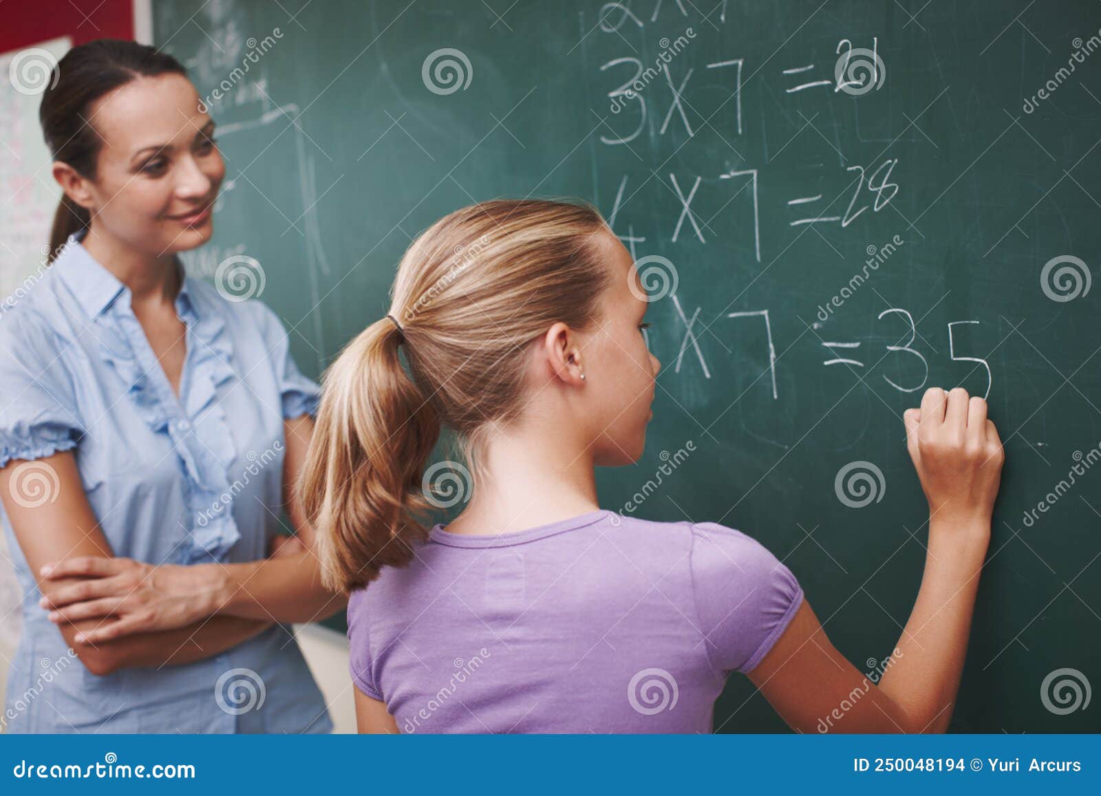Improving on Her Mathematics. a Pretty Young Teacher Helping Her ...
