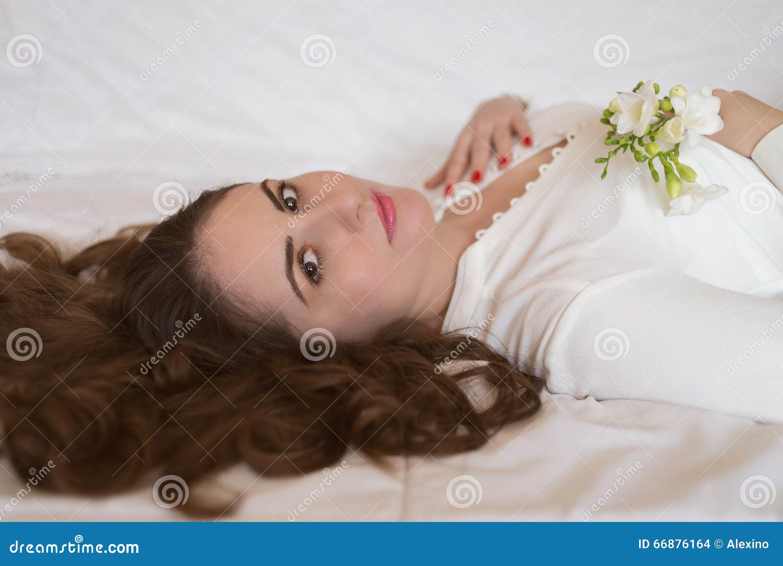 Pretty Young Woman With Beautiful Long Hair Lying On The Bed Stock