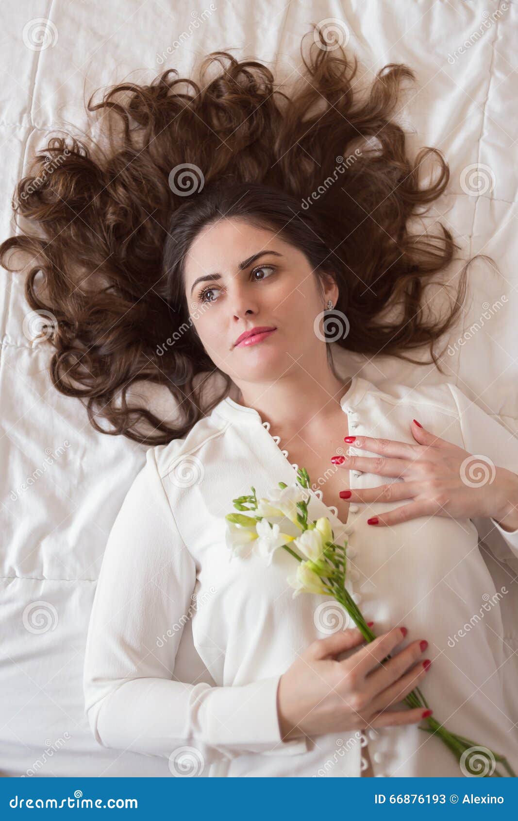 Pretty Young Woman With Beautiful Long Hair Lying On The Bed Stock