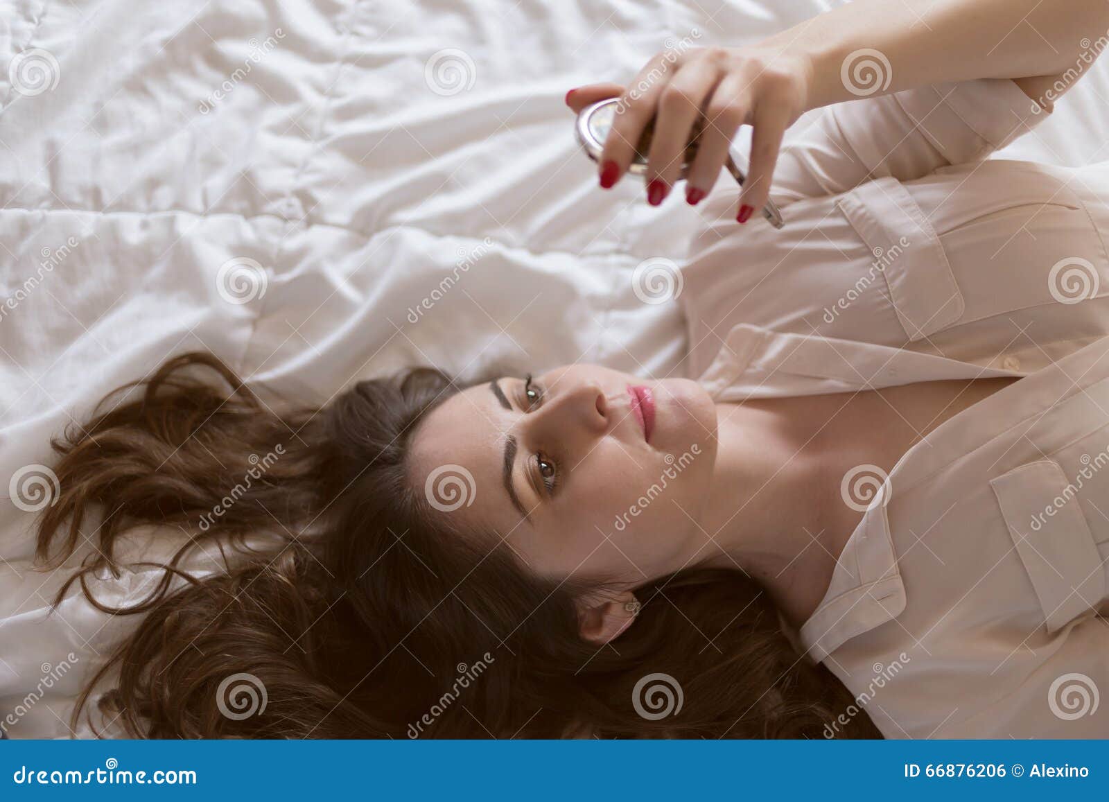 Pretty Young Woman With Beautiful Long Hair Lying On The Bed Stock