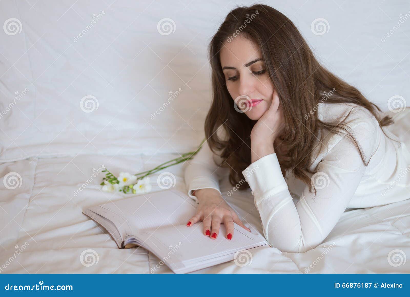Pretty Young Woman With Beautiful Long Hair Lying On The Bed Stock