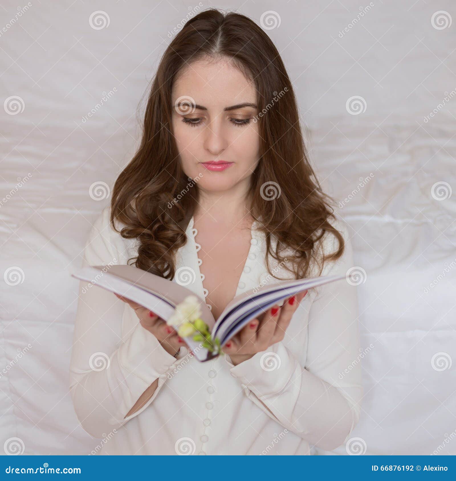 Pretty Young Woman With Beautiful Long Hair Lying On The Bed Stock