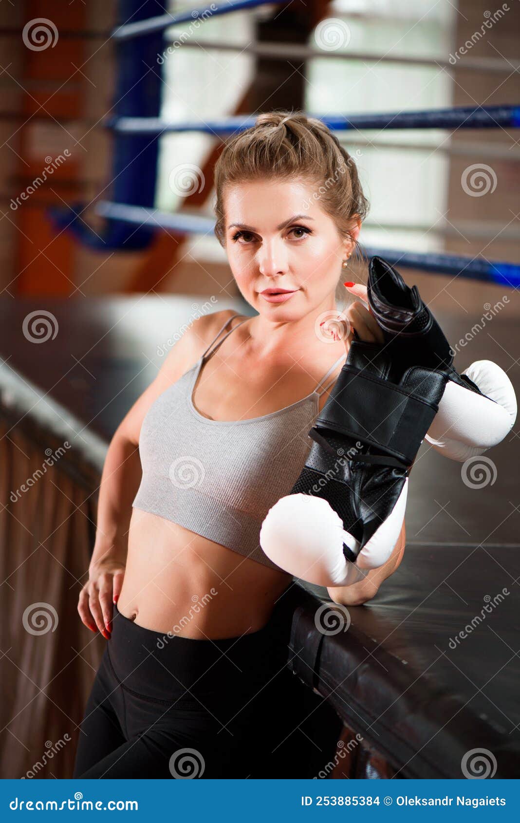 Pretty Young Woman with Boxing Gloves Posing and Looking at the Camera ...