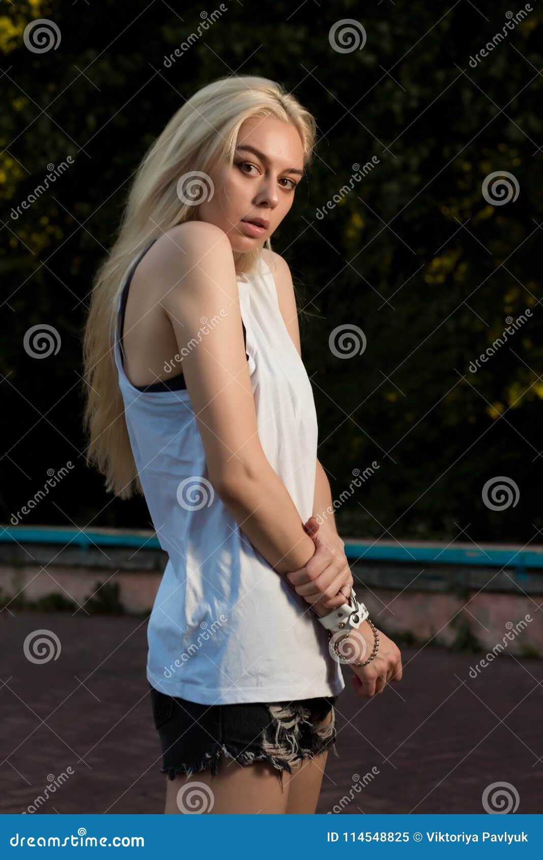 Pretty Blonde Girl With Long Hair Dressed In Fashionable Clothes Stock