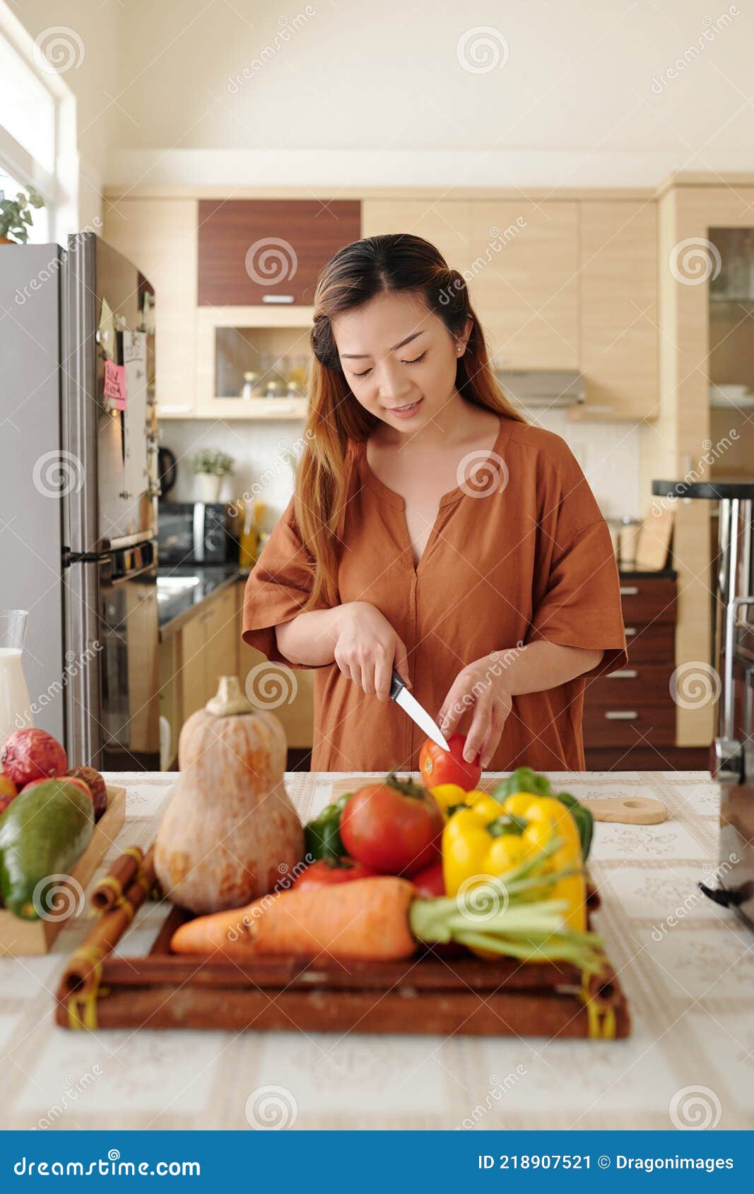Woman cooking dinner stock image. Image of smiling, eating - 218907521