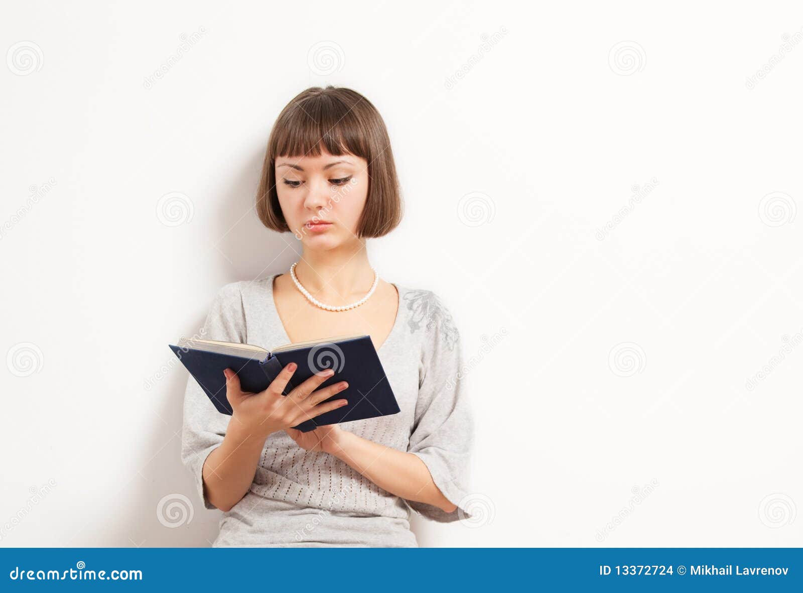 PRetty Young Woman Reading Book Stock Photo - Image of serious, wall ...