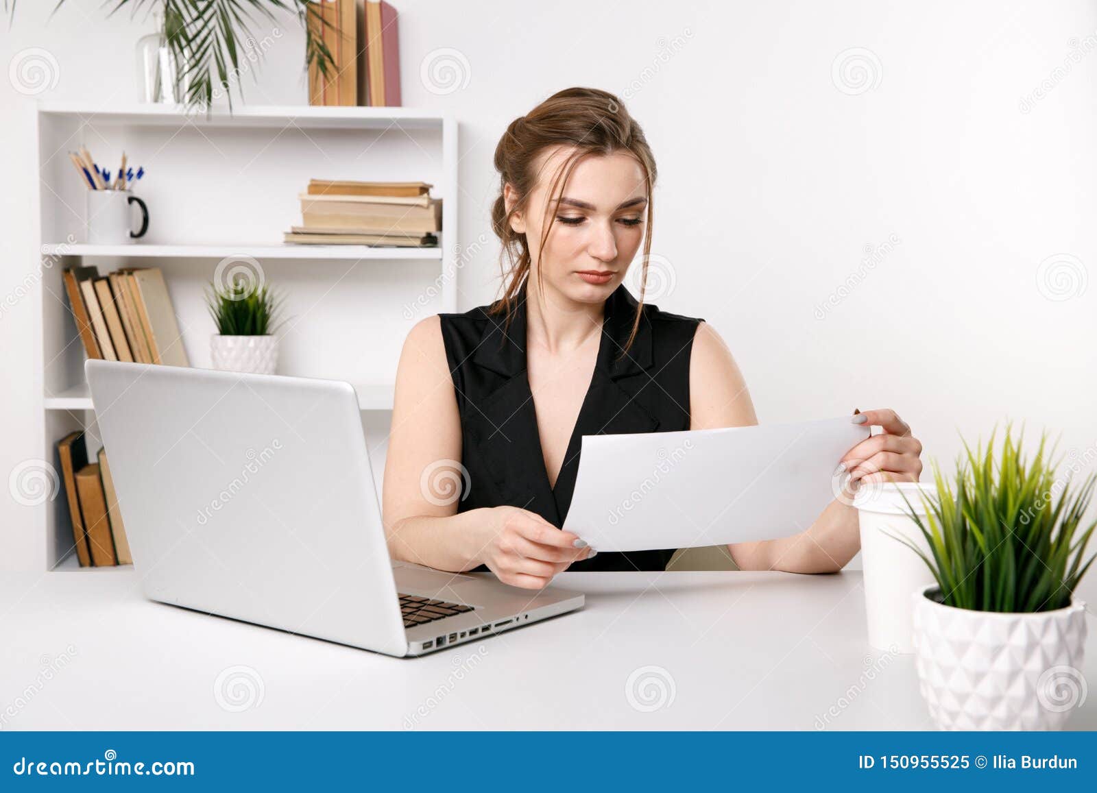 Pretty Young Woman Working with Documents Sitting Infront of Her ...