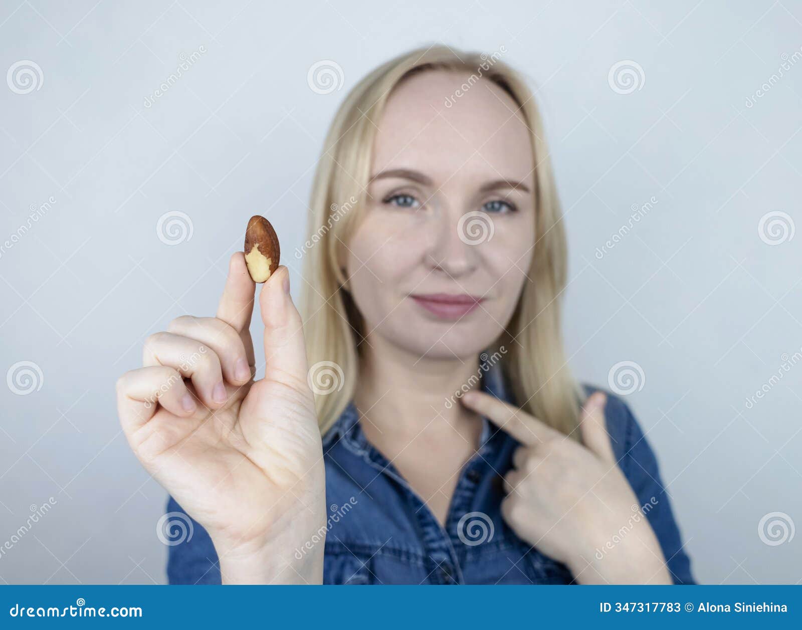 Prevention of Thyroid Diseases. Woman Holds Brazil Nuts, Rich in ...