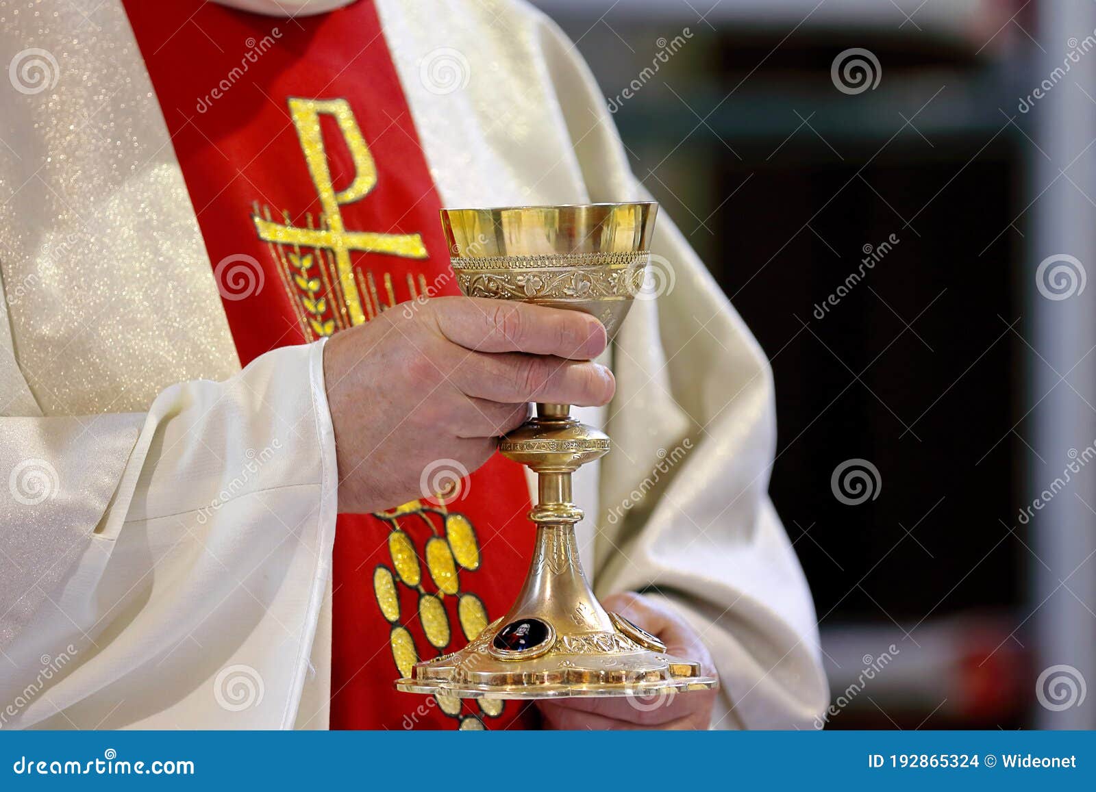 Priest Holds the Chalice while Celebrating the Mass and Empty Space for ...