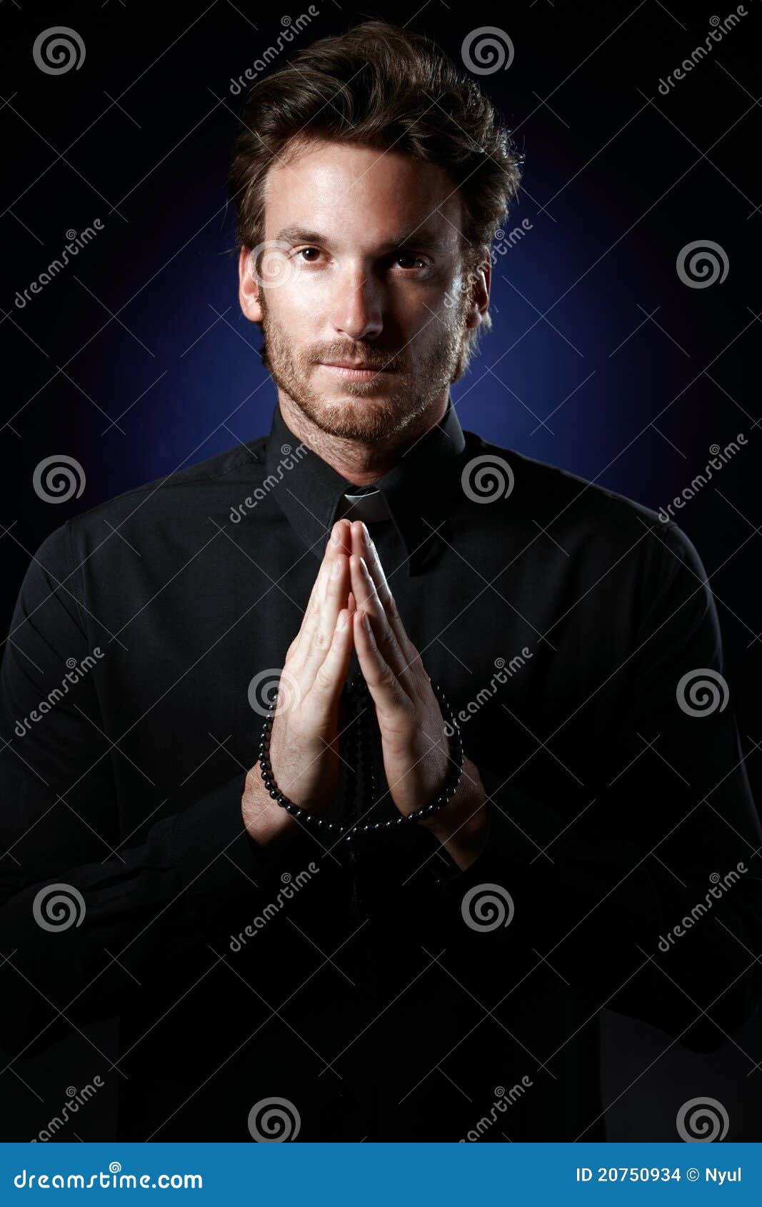 Priest praying with rosary stock photo. Image of dark - 20750934