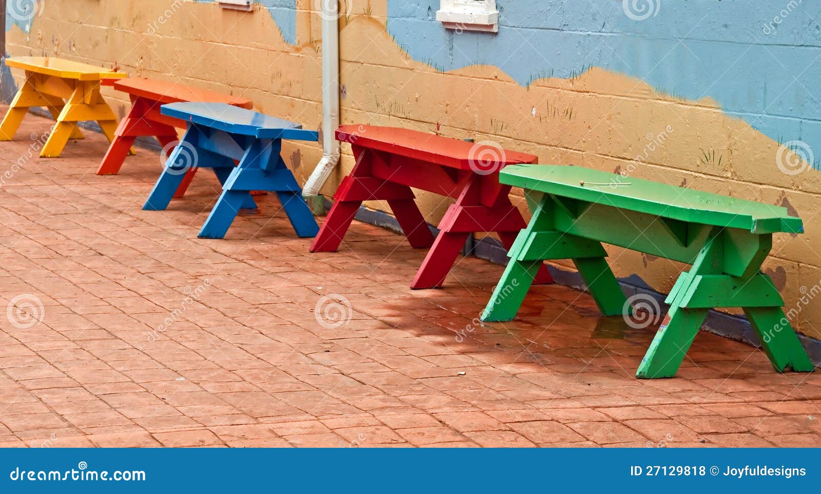 Primary Colored Benches in Row on Bricks Stock Photo - Image of bricks ...