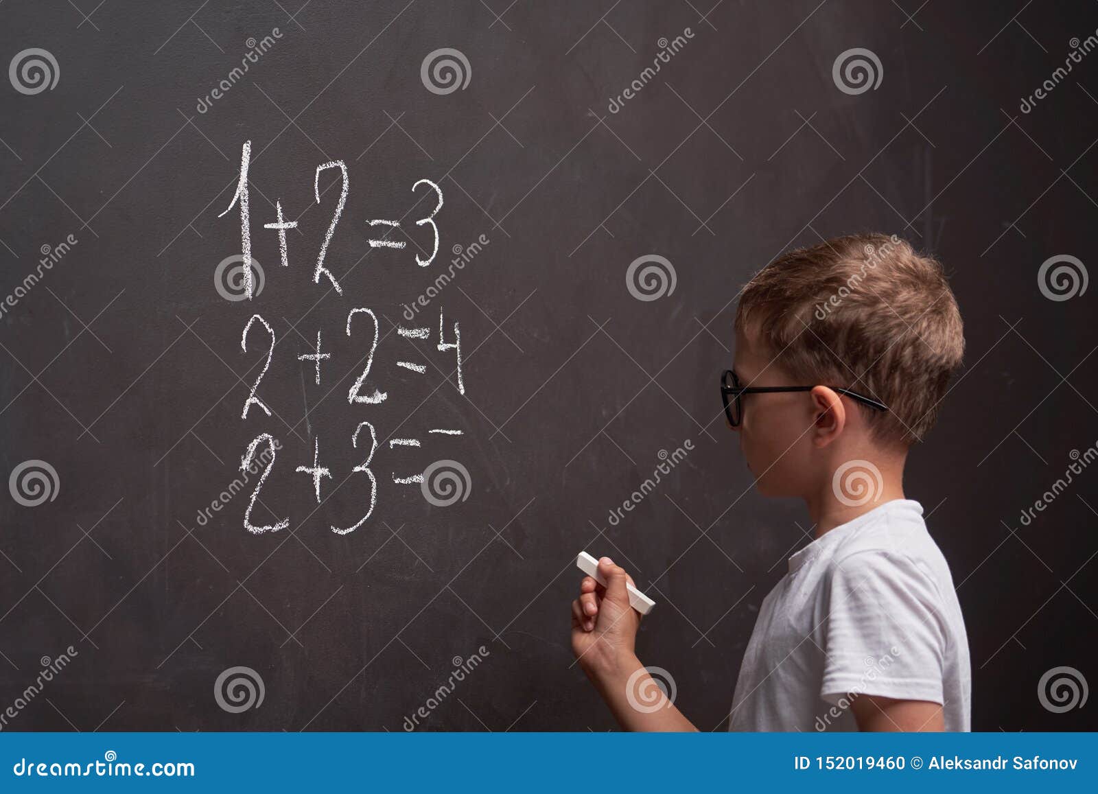 The Boy Solves Mathematical Examples. A Child Solves Examples On A ...