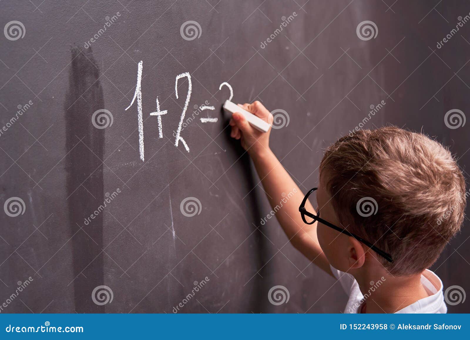 Primary Education. Rear View Of A Schoolboy Solves A Mathematical ...