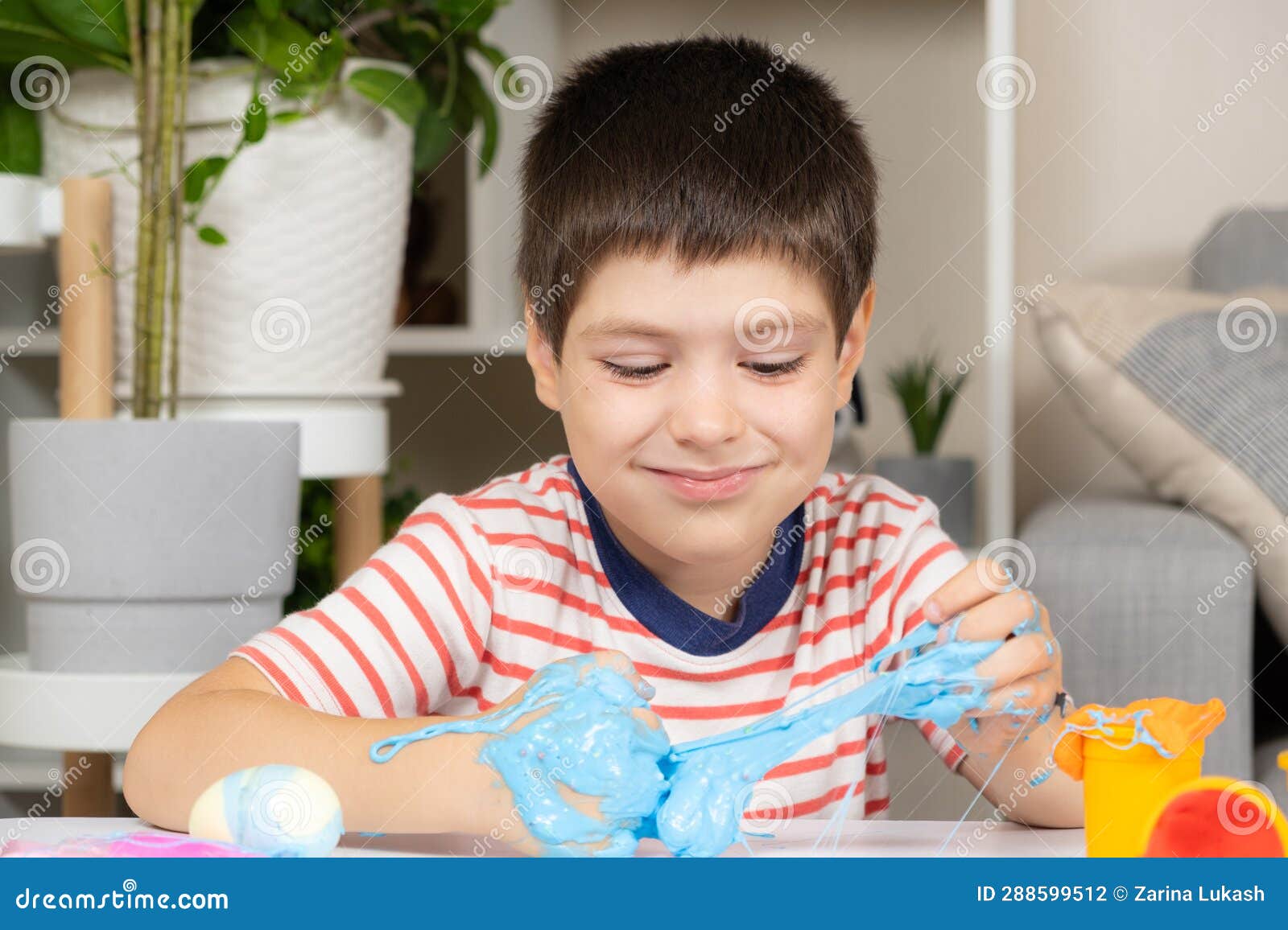 A Primary School Child Plays with a Slime, a Pully Sticky Toy for the ...