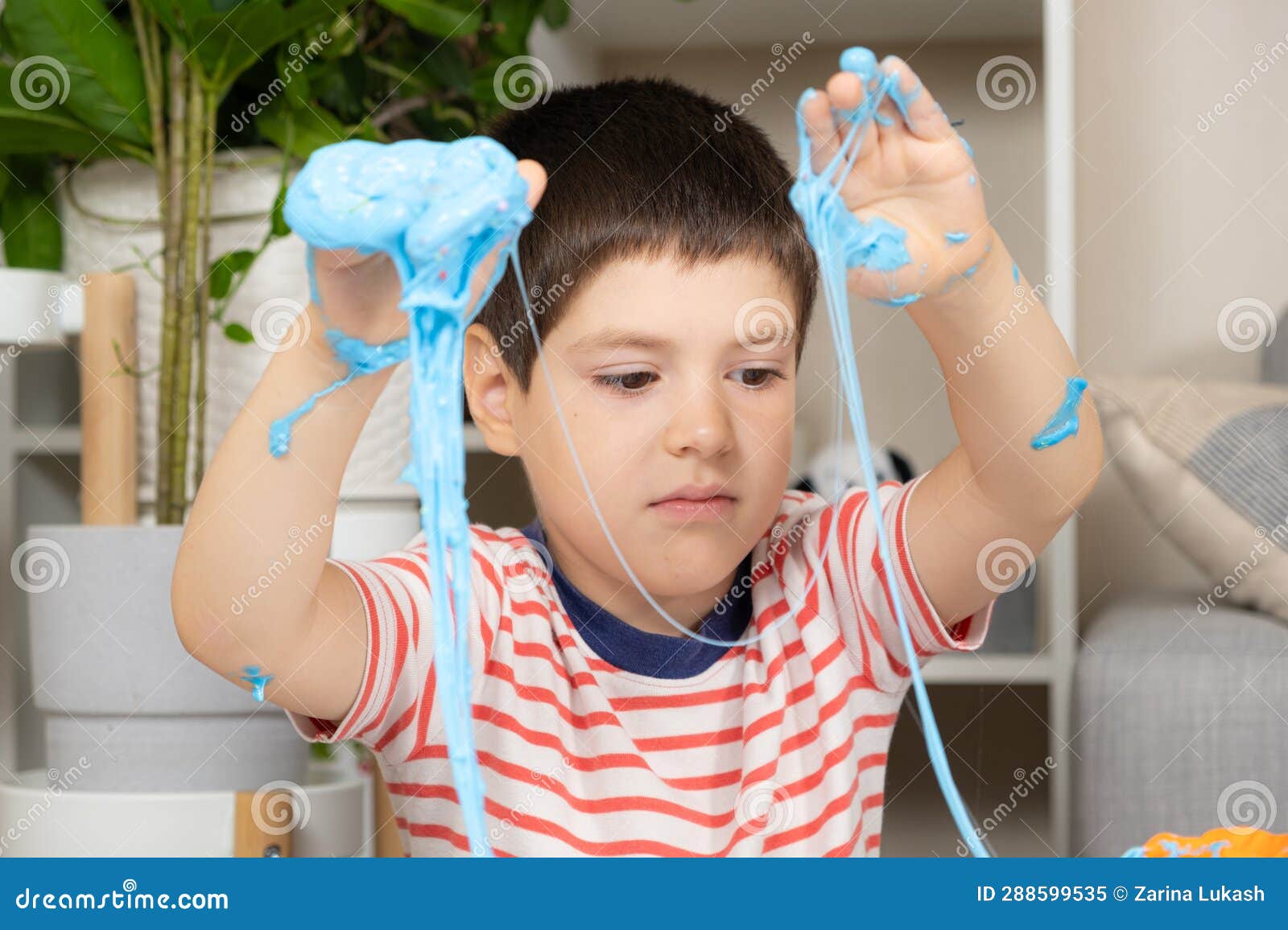 A Primary School Child Plays with a Slime, a Pully Sticky Toy for the ...