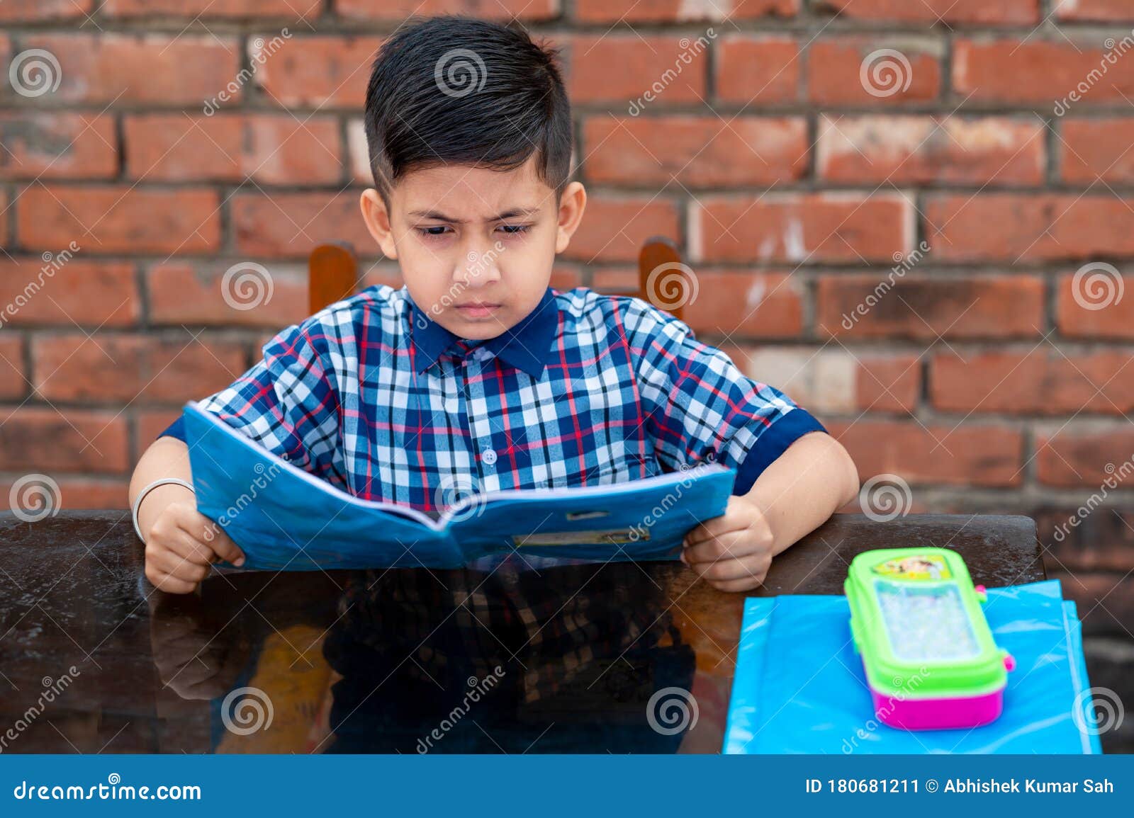 Primary School Student in Proper School Uniform Reading Book on Study ...