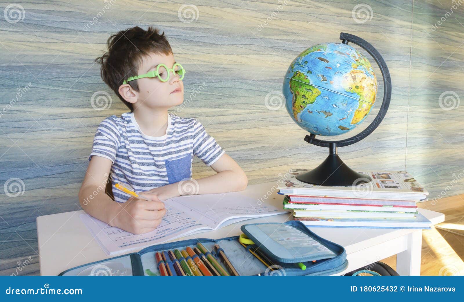 A Primary School Student with Round Glasses is in a Geography Lesson in ...