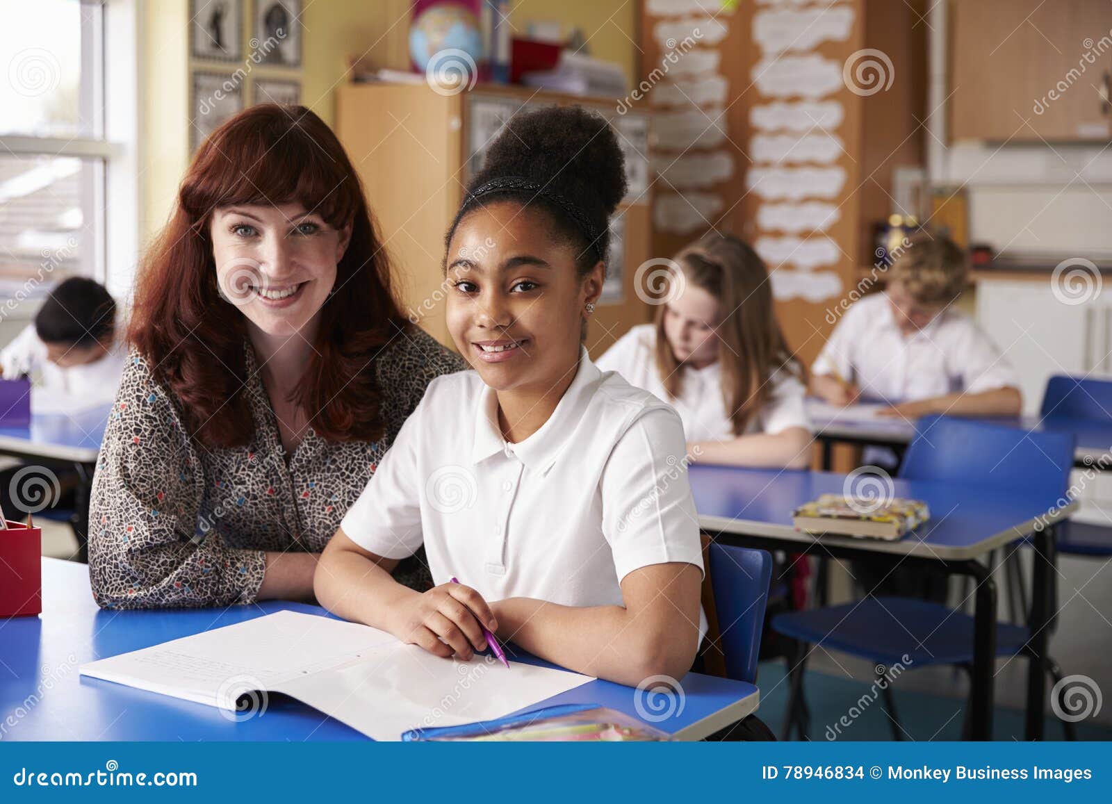 Primary School Teacher and Girl in Class Looking To Camera Stock Photo ...