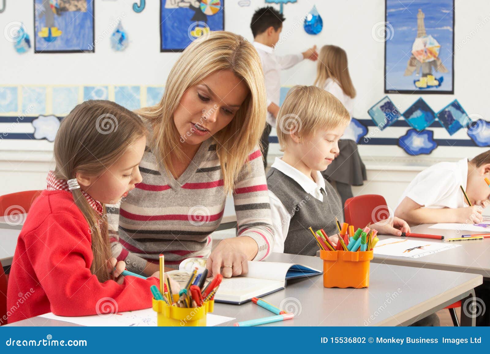Primary Schoolchildren and Teacher Having a Lesson Stock Photo - Image ...
