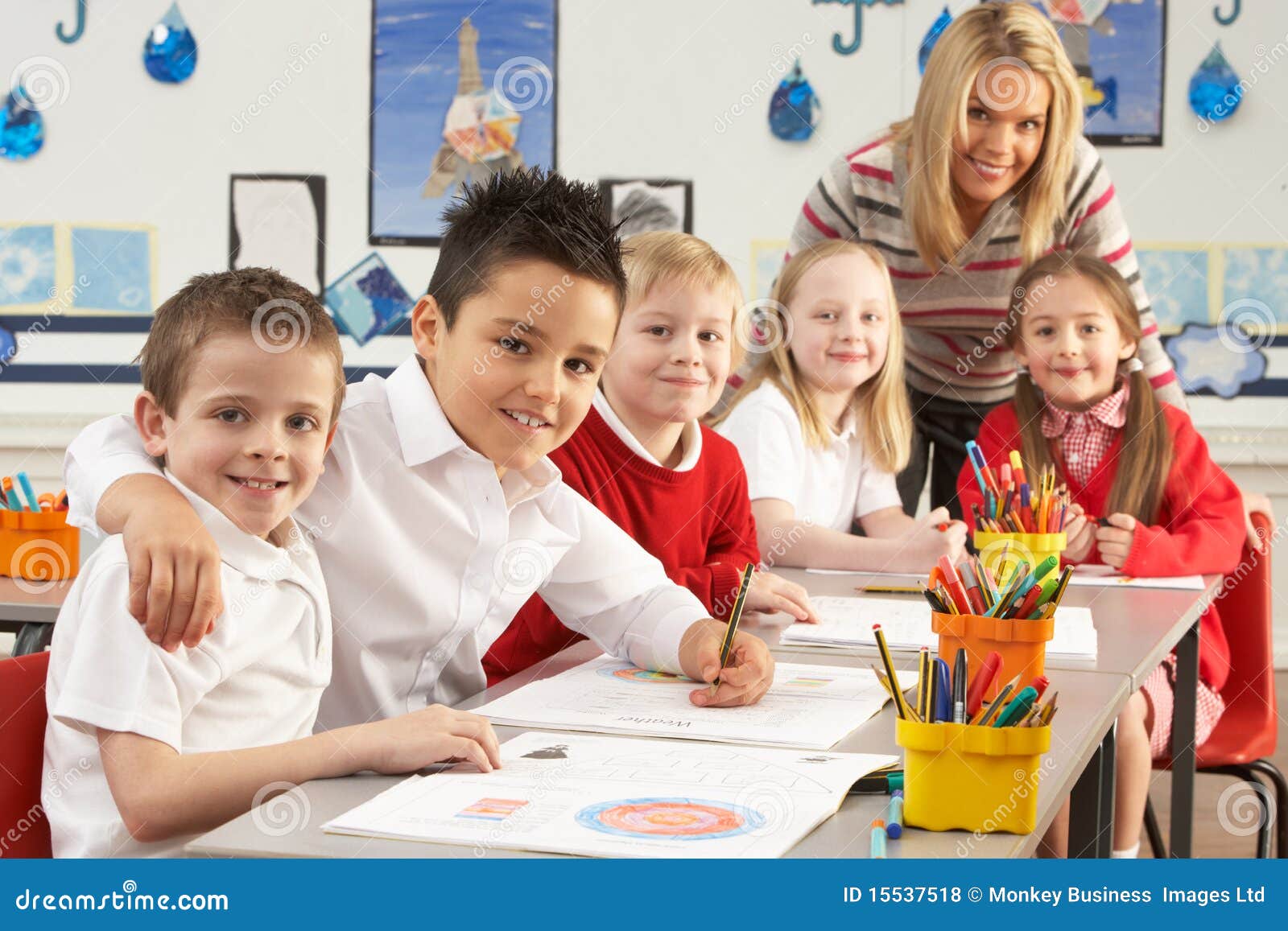 Primary Schoolchildren And Teacher At Desk Stock Image | CartoonDealer ...