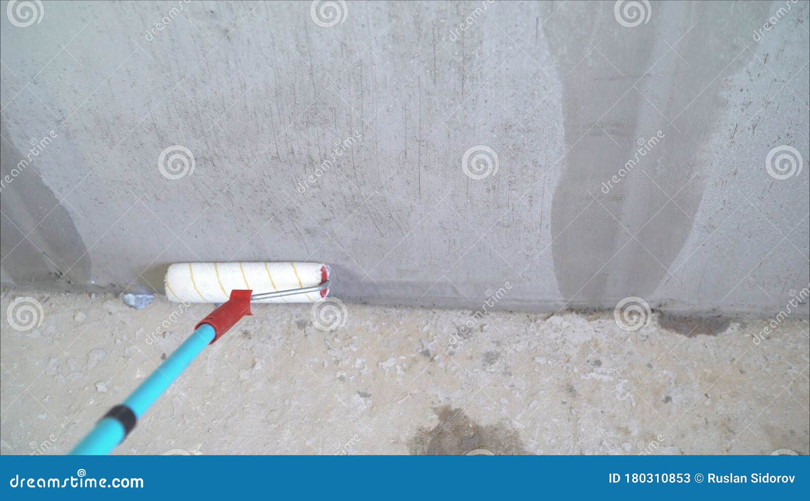 Primer Application by Roller. the House is Under Construction. Worker ...