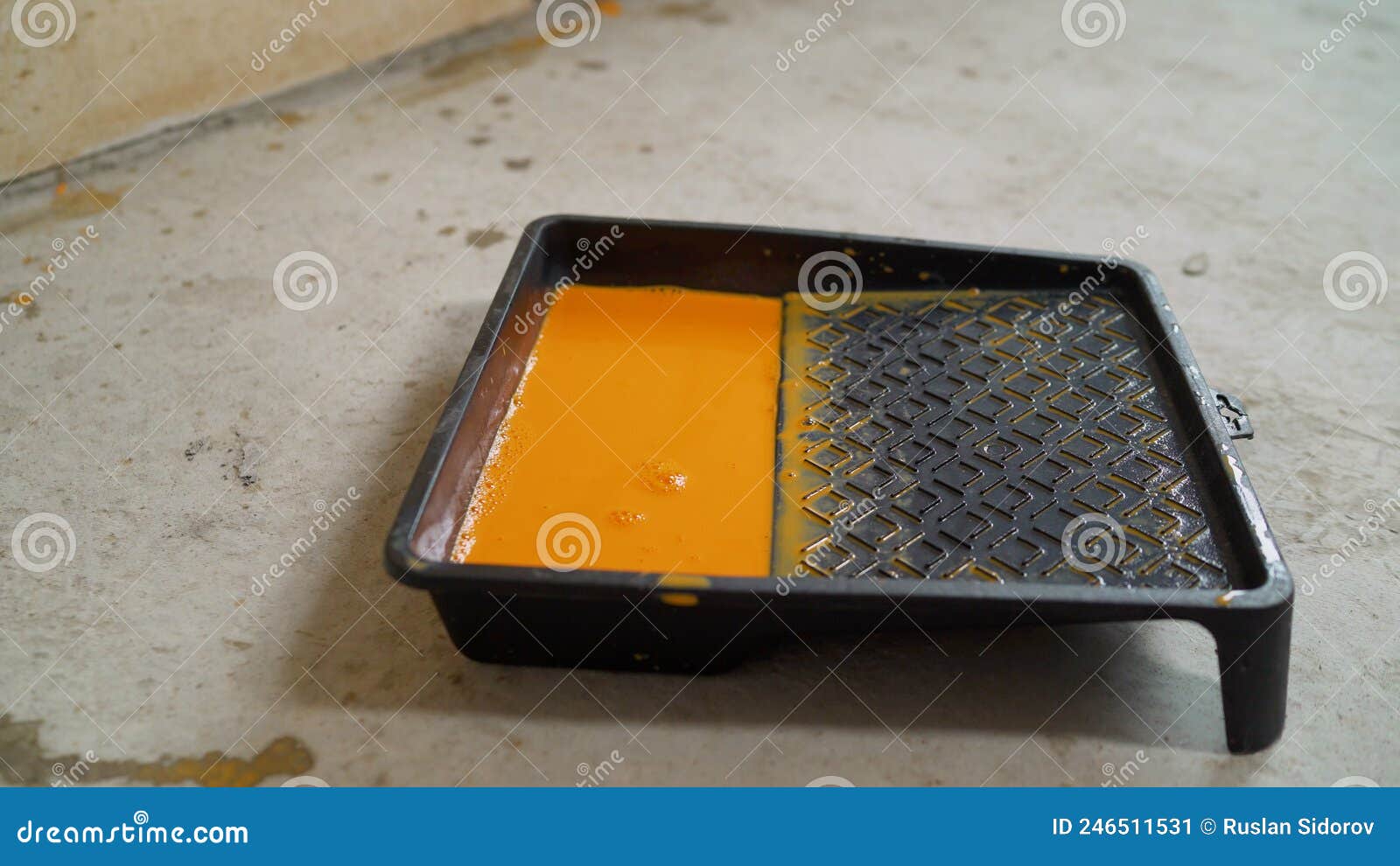 Primer is Poured into a Paint Tray. Orange Primer in the Tray. Stock ...