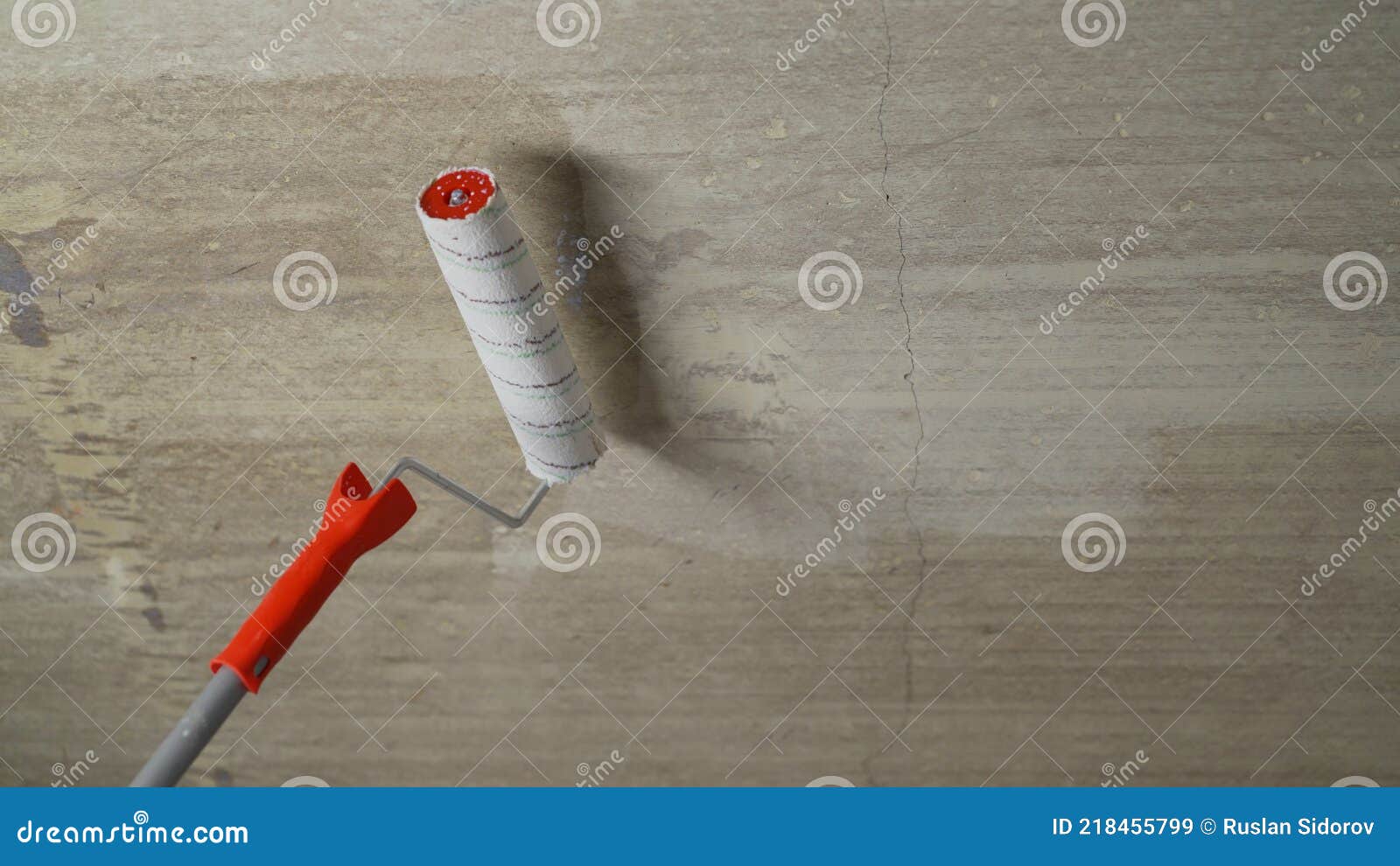 Working Primer with a Ceiling Paint Roller. Close-up of Concrete ...