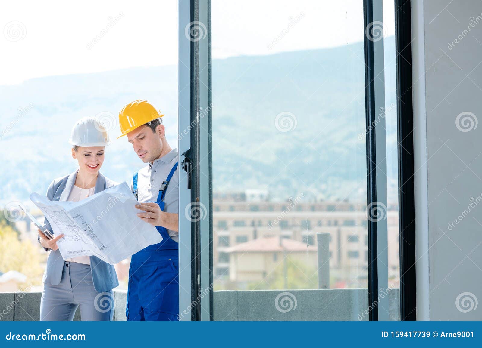 Principal and Builder Reading Blueprints on Construction Site Stock ...