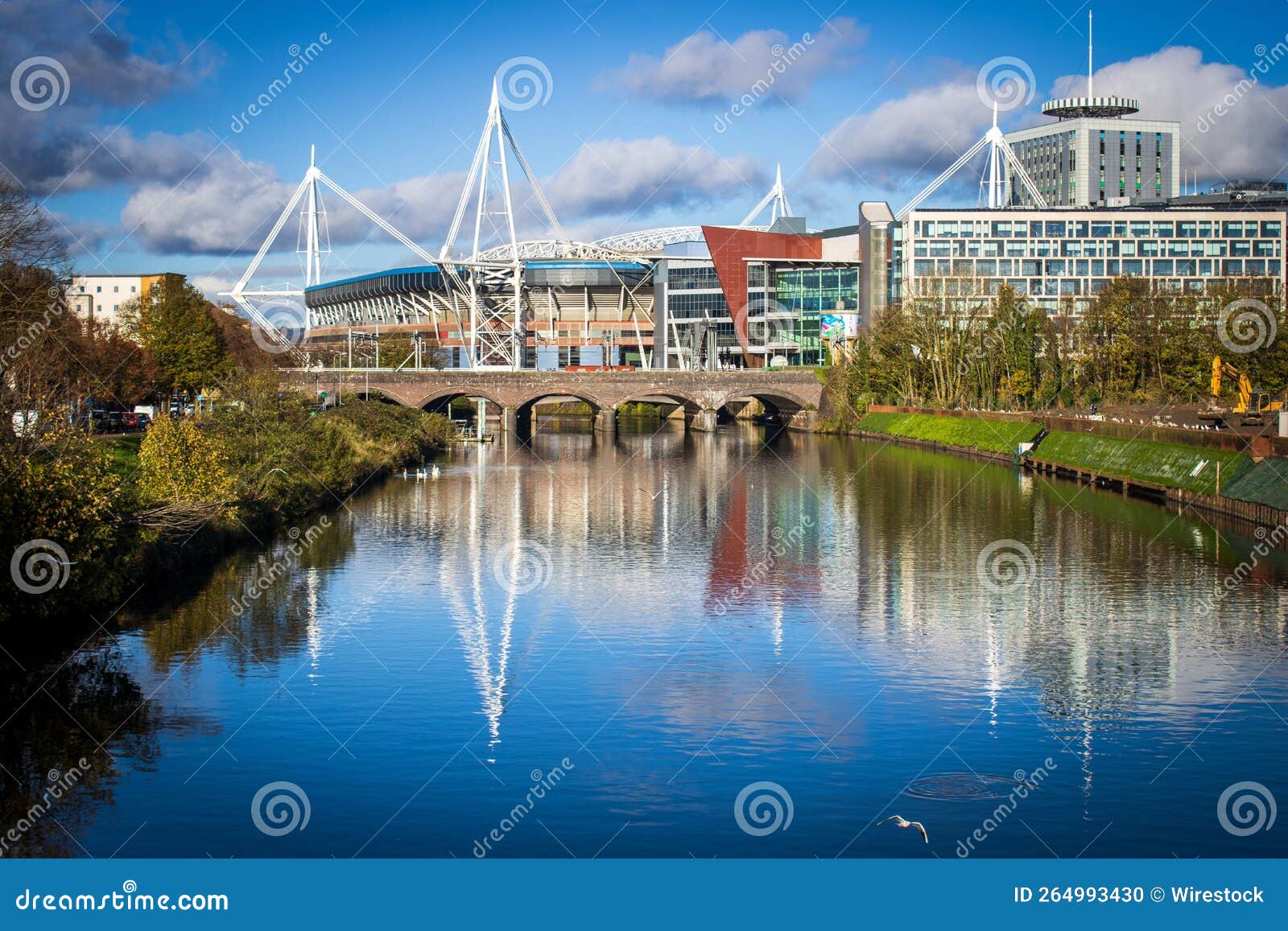 Principality Stadium Reflecting on a River with Bridge Under a Blue Sky ...