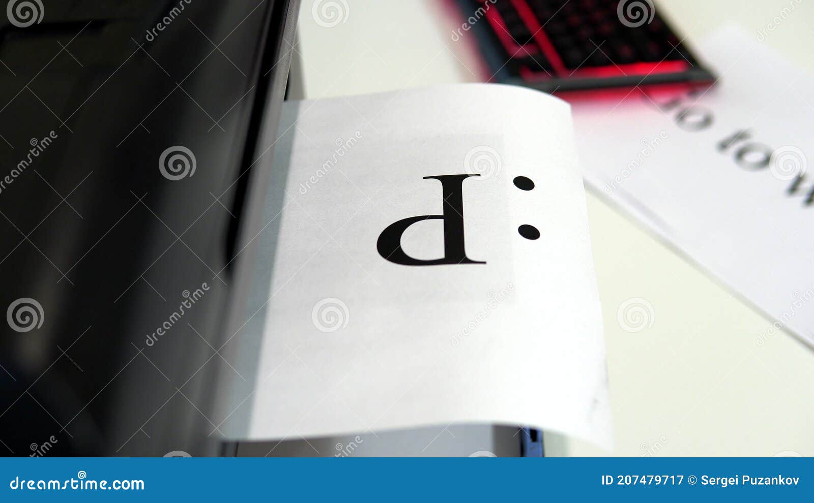 The Printer on the Table Printed a Smiley Face with a Tongue on a Piece ...
