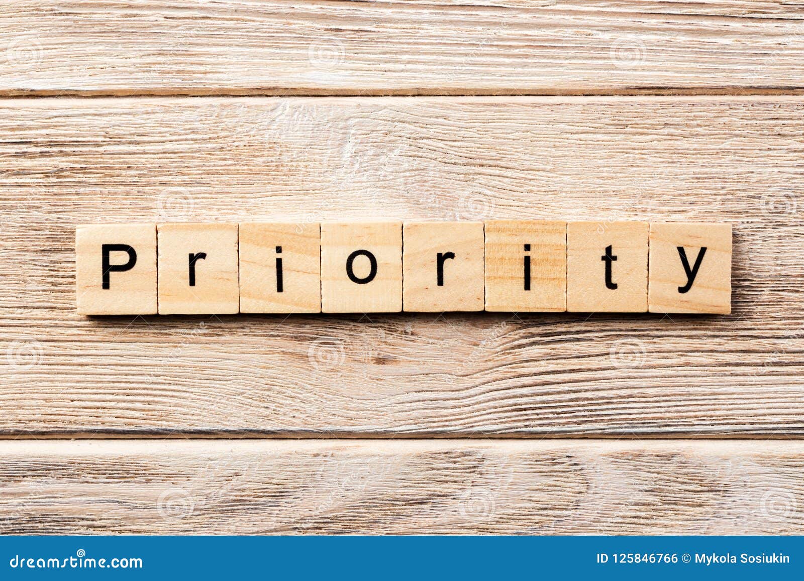 Priority Word Written on Wood Block. Priority Text on Table, Concept ...