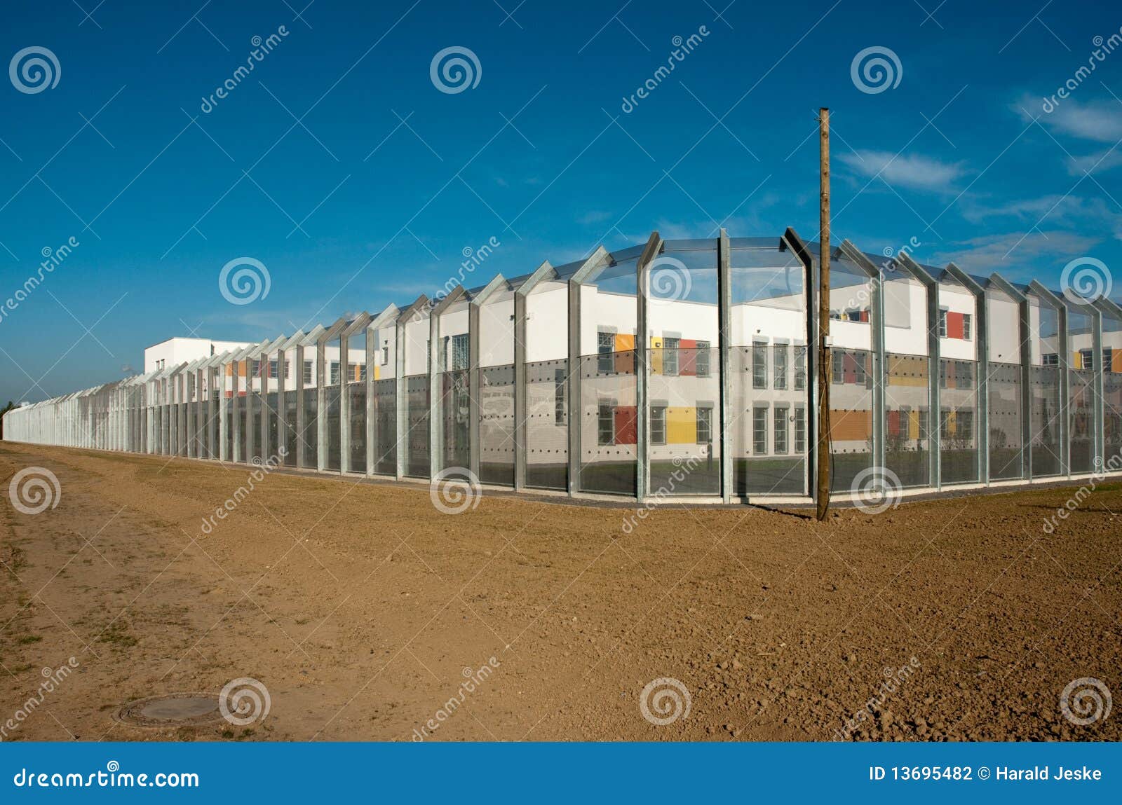 Prison behind the fence stock photo. Image of skies, building - 13695482