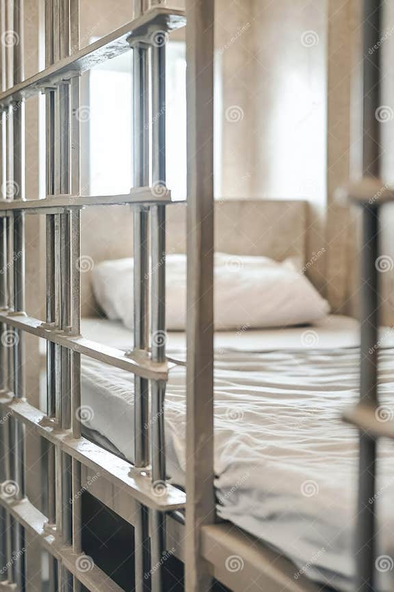 Prison Cell Bars Framing Empty Bed and Window Stock Photo - Image of ...