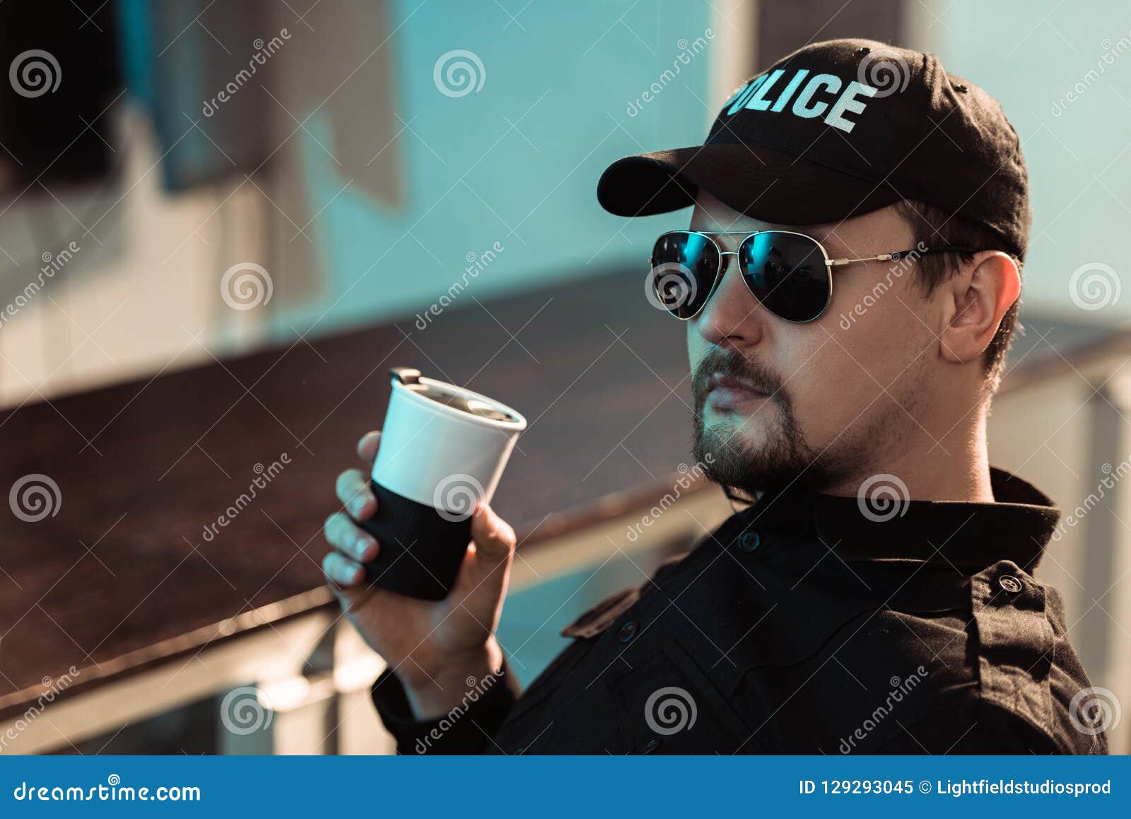 Prison guard holding cup stock image. Image of penitentiary - 129293045