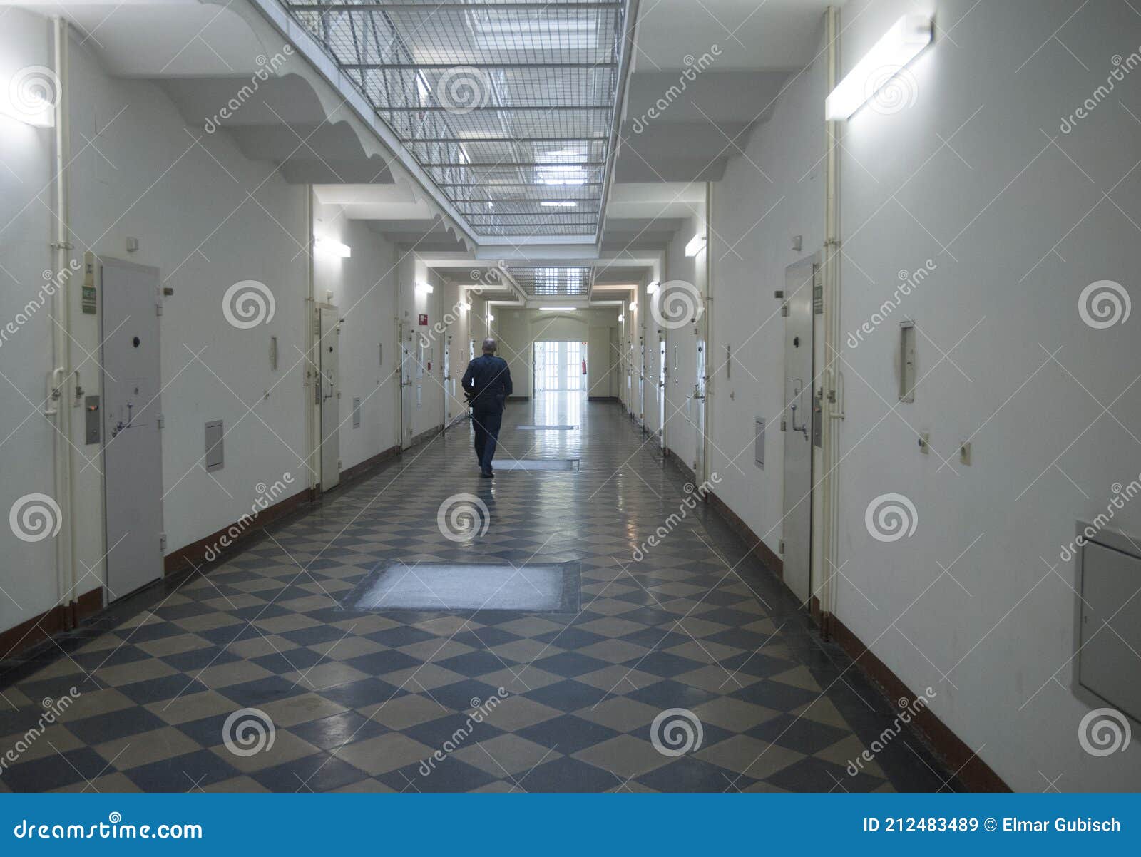 Prison Guard Walking Down Corridor of a Prison Stock Image - Image of ...