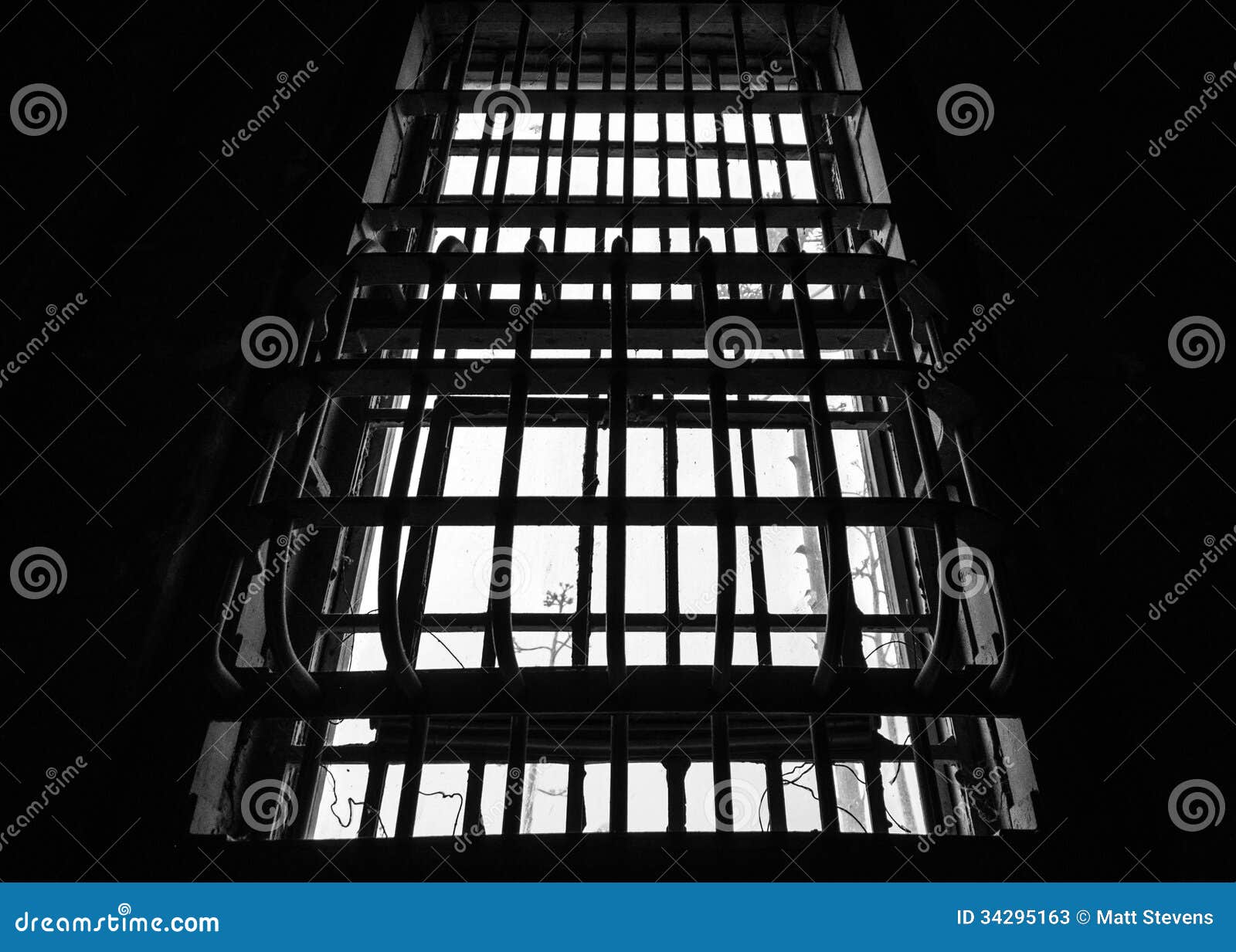 An Old Prison Window With A Stone Wall Grille With A Cross Symbol Of ...
