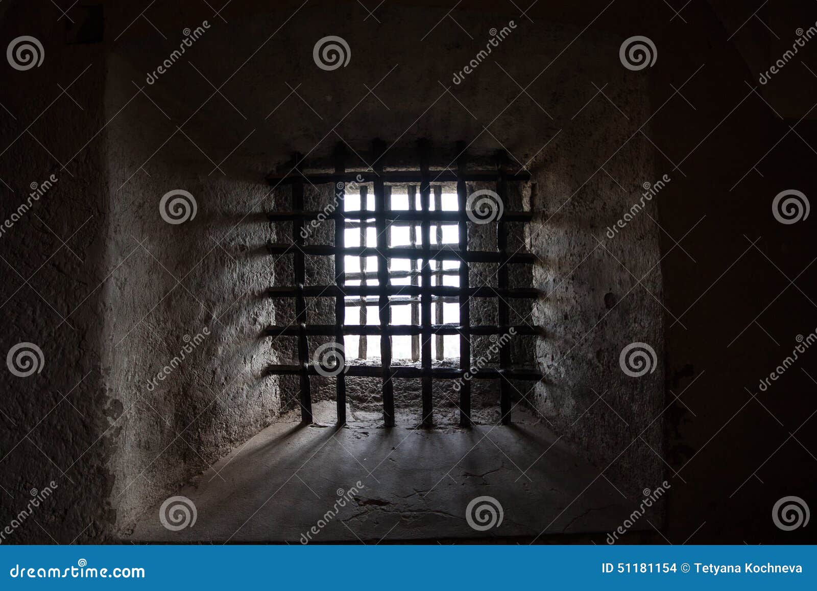 An Old Prison Window With A Stone Wall Grille With A Cross Symbol Of ...