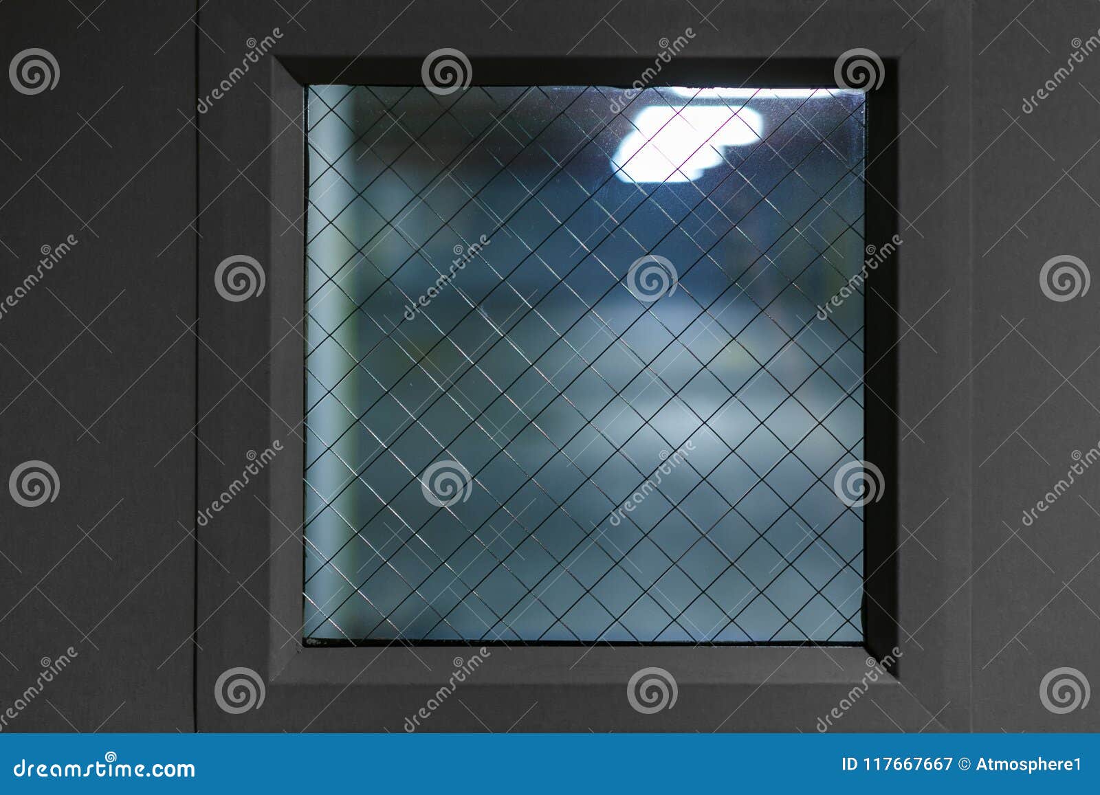 Prison Window with Wired Protection Showing Empty Blue Hall Behind with ...