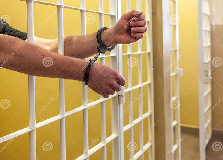 Prisoner in Handcuffs Locked in a Cell. Stock Image - Image of caught ...