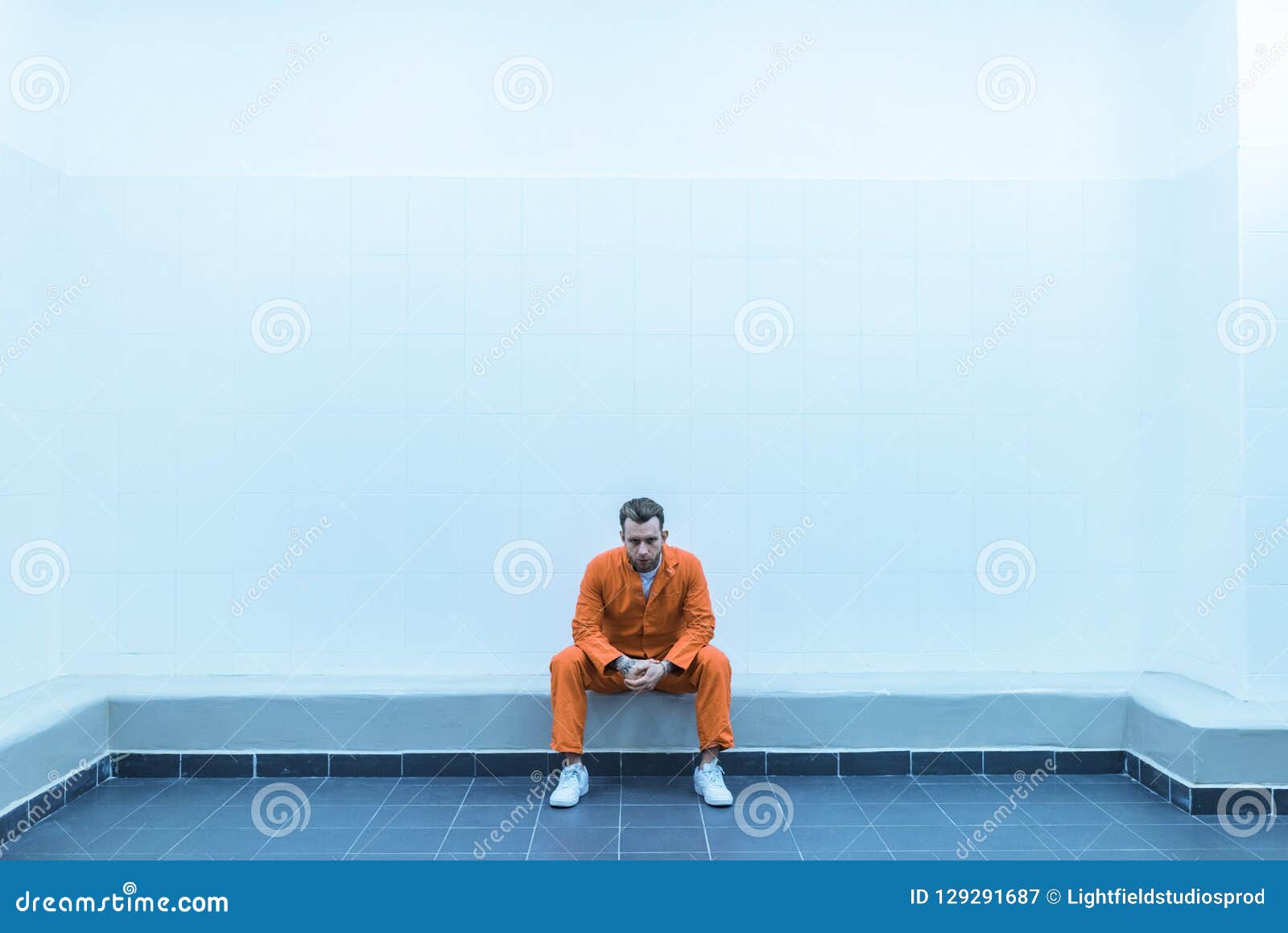 Prisoner sitting on bench stock image. Image of prisoncell - 129291687