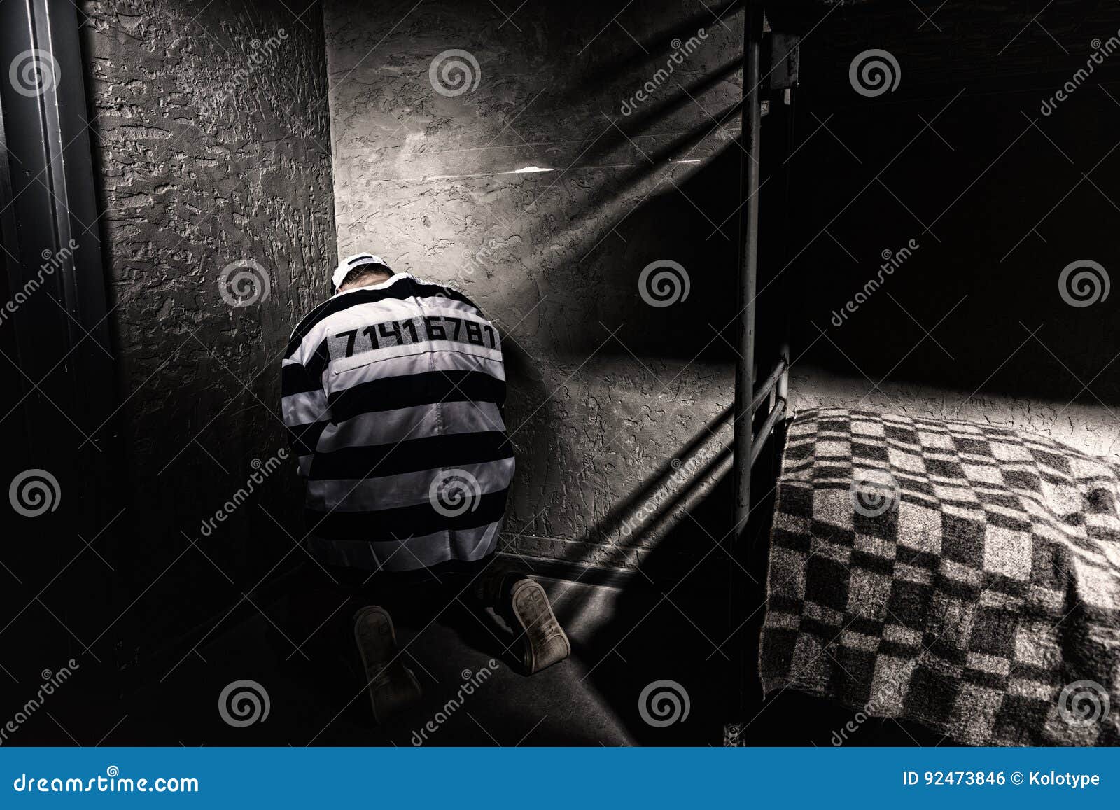 Prisoner is Sitting in the Corner in a Small Prison Cell Stock Photo ...