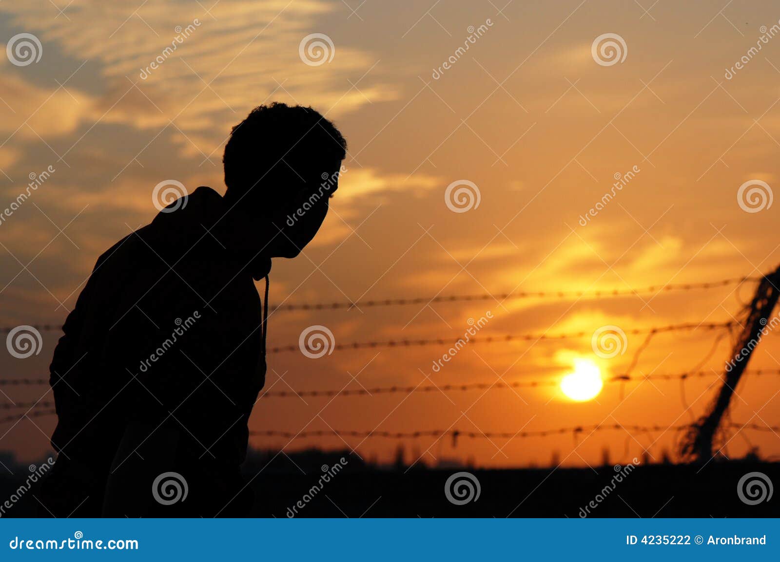 Prisoner at sunset stock photo. Image of fence, sunset - 4235222