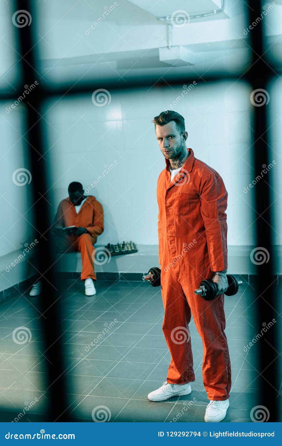 Prisoner Training with Dumbbells in Prison Room and Looking Stock Photo ...