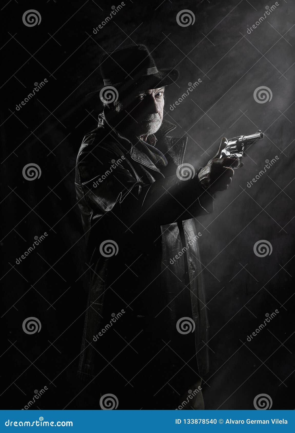A Private Detective with a Revolver in Front of a Black Backdrop Stock ...
