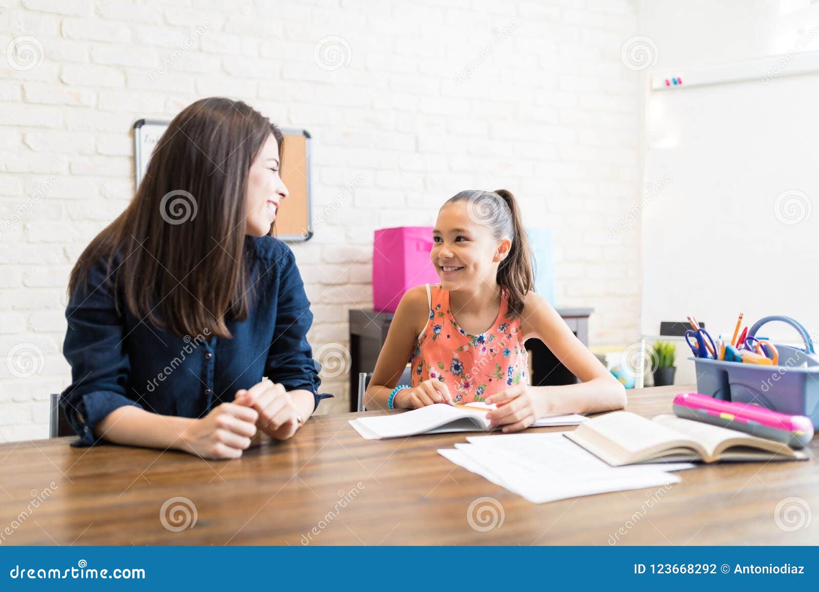 Private Tutor and Student Looking at Each Other at Table Stock Photo ...