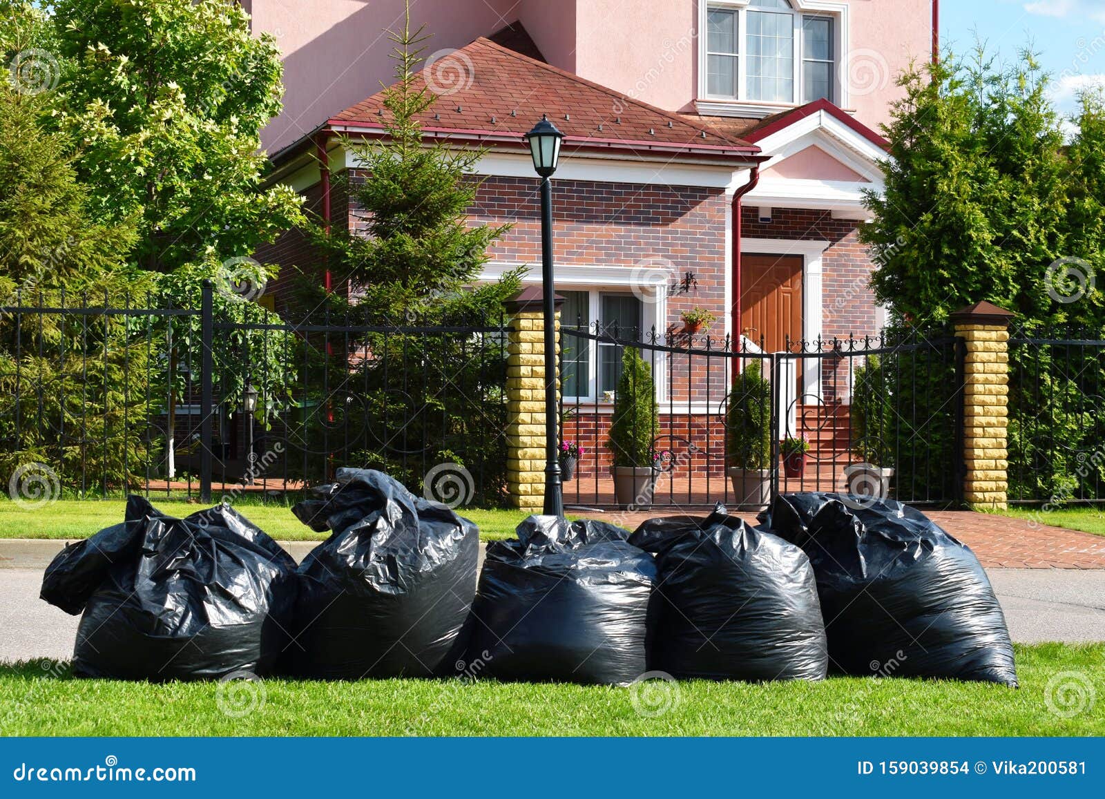 Big Black Trash Bag on the Lawn. Cleaning the Area Stock Photo - Image ...